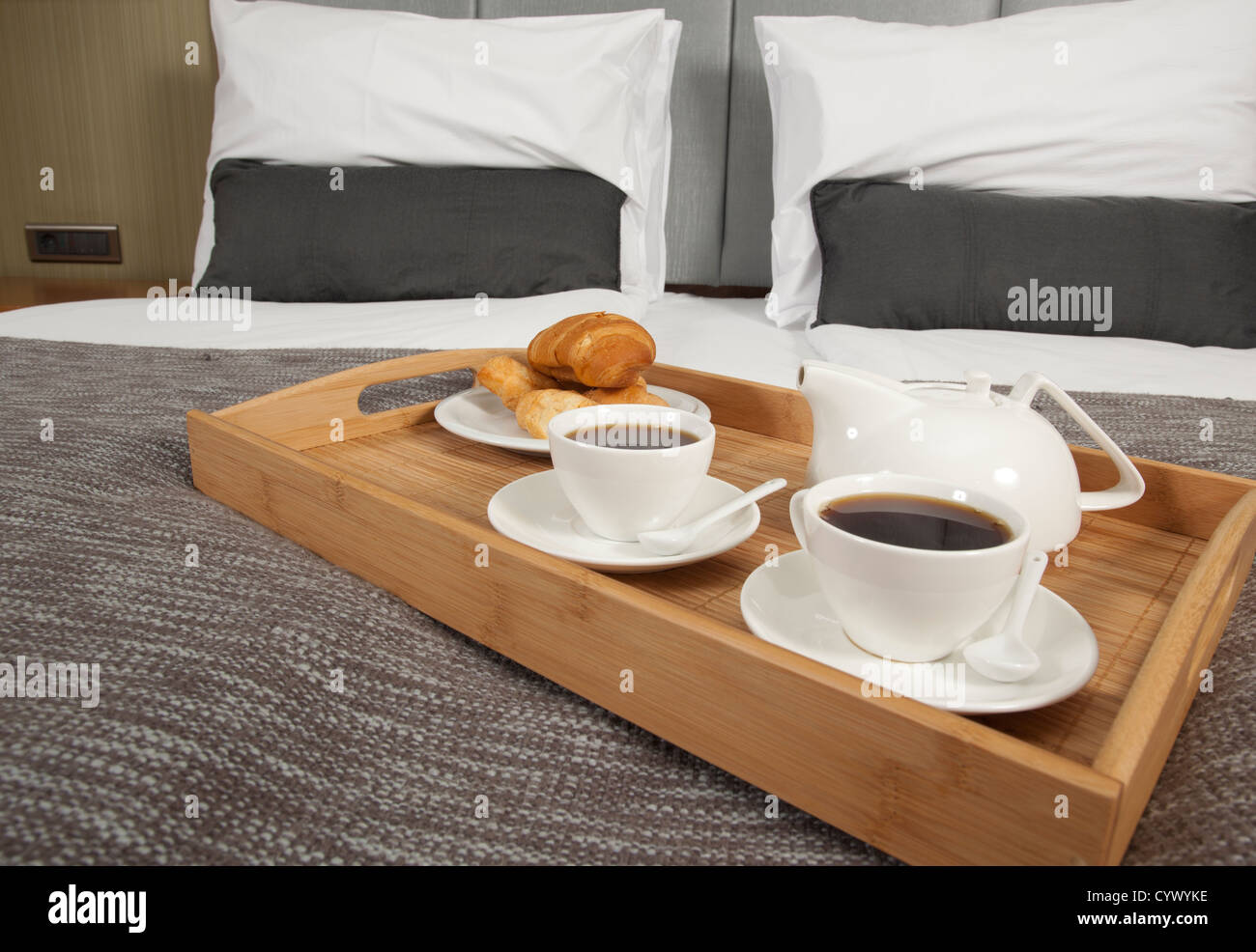 Tray with coffee on a bed in a hotel room Stock Photo - Alamy