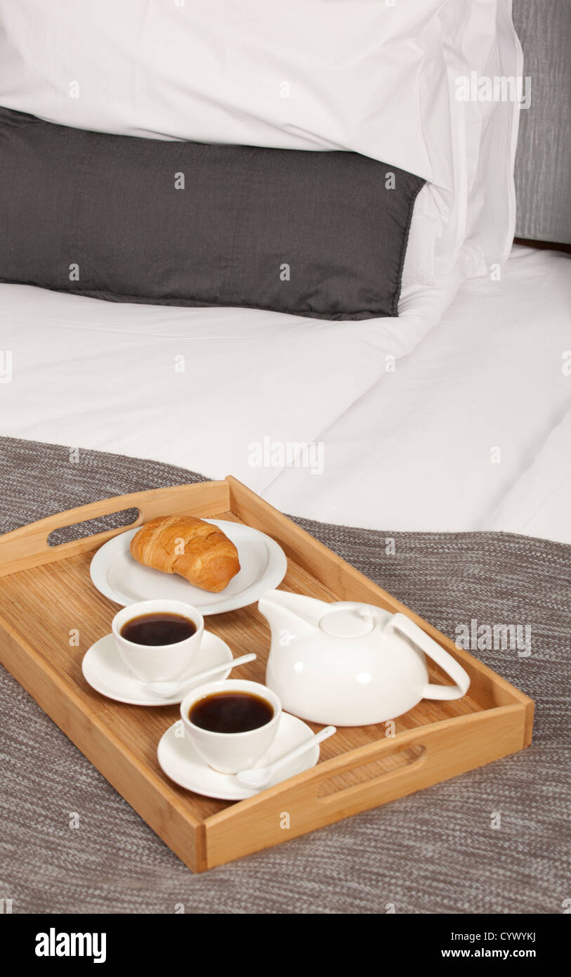 Tray with coffee on a bed in a hotel room Stock Photo - Alamy