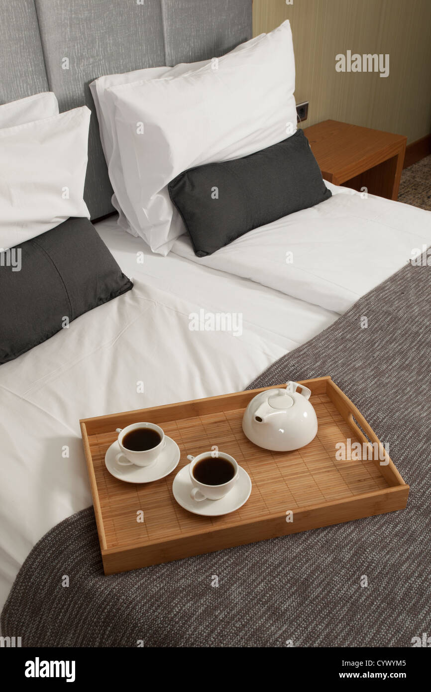 Tray with coffee on a bed in a hotel room Stock Photo - Alamy