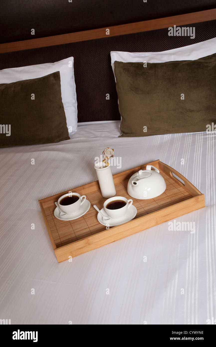 Tray with coffee on a bed in a hotel room Stock Photo - Alamy