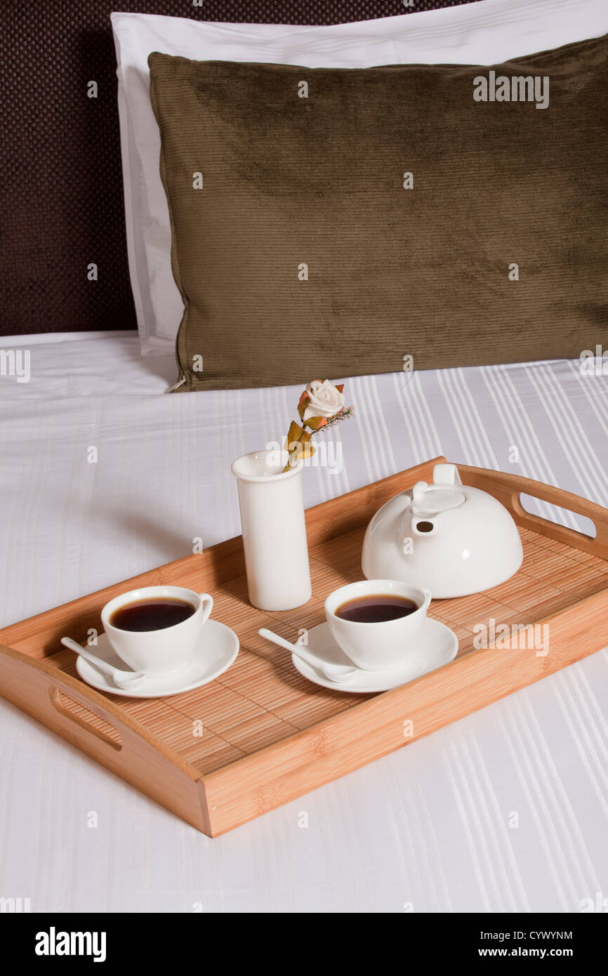 Tray with coffee on a bed in a hotel room Stock Photo - Alamy