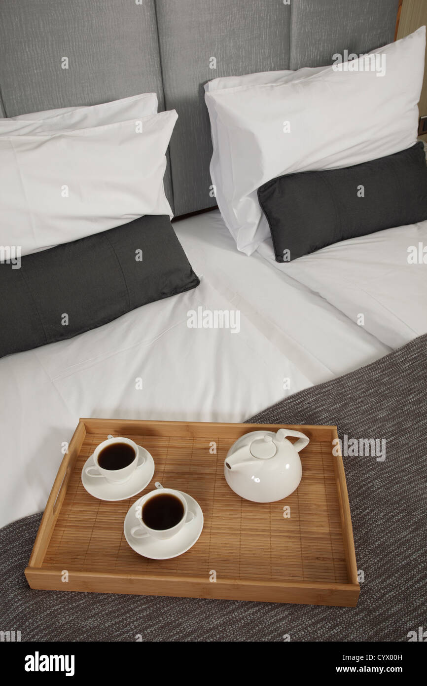 Tray with coffee on a bed in a hotel room Stock Photo - Alamy