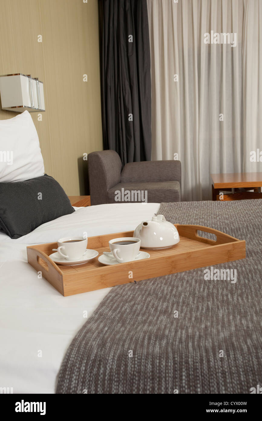 Tray with coffee on a bed in a hotel room Stock Photo - Alamy