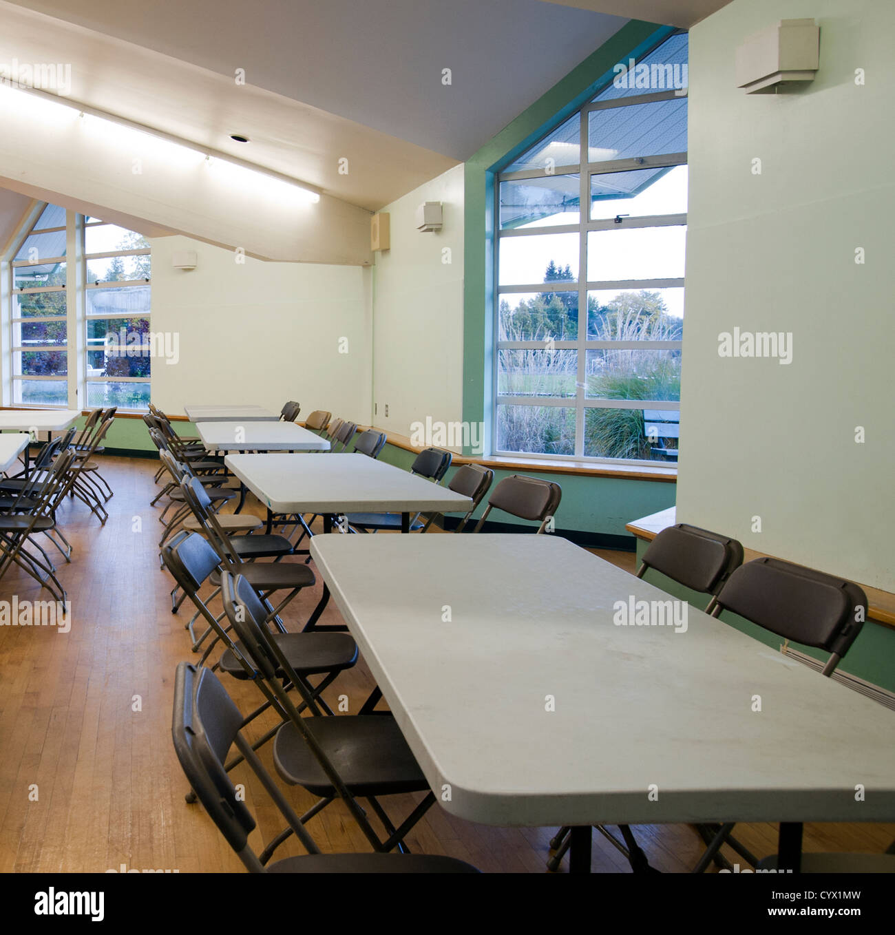 Tables and chairs set up in large community room Stock Photo - Alamy