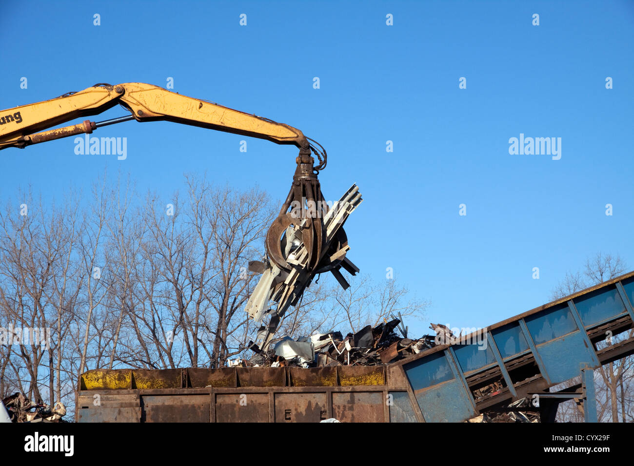 Grappling Crane dropping metal objects into shredder at Metal Recycling ...