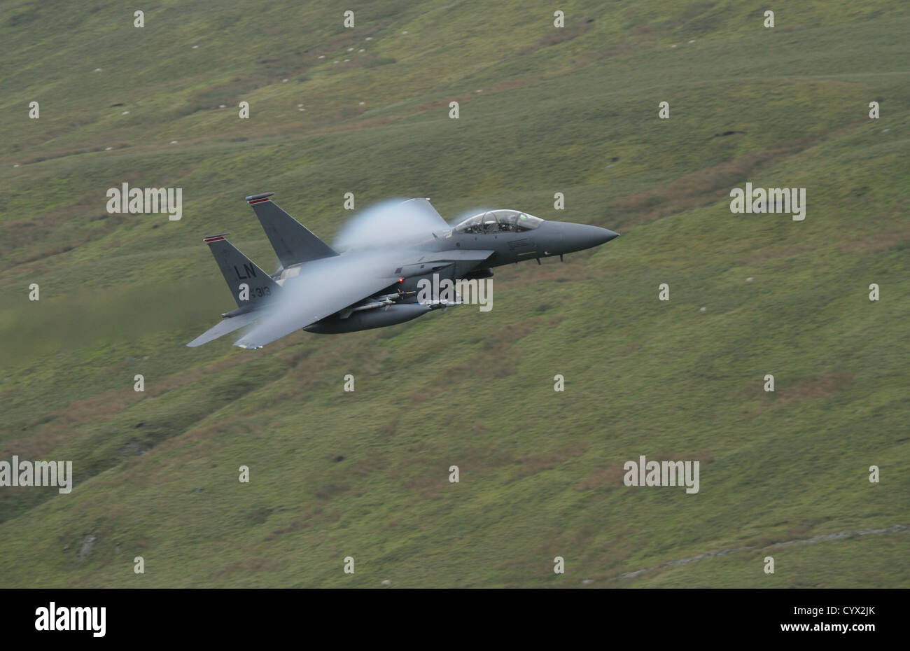 F15 eagle usaf strike plane low flying through valley in wales Stock ...