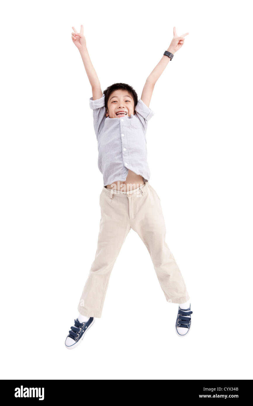 Cute boy doing victory sign Stock Photo - Alamy