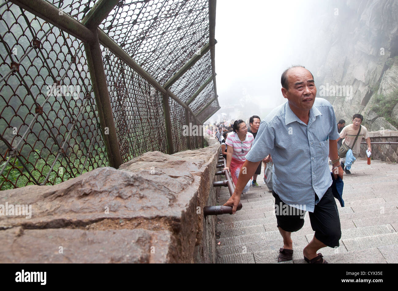 A man looking towards the summit of Tai Shan from the Stairway to ...