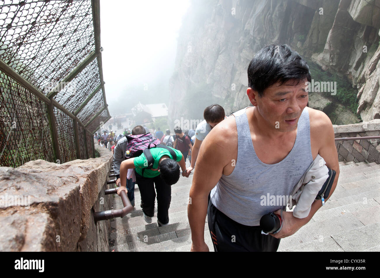 An exhausted tourist climbing the Stairway to Heaven, Mount Tai ...