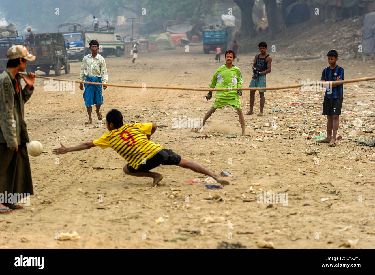 Children playing soccer on the Ayeyarwady River banks in Myanmar Burma ...