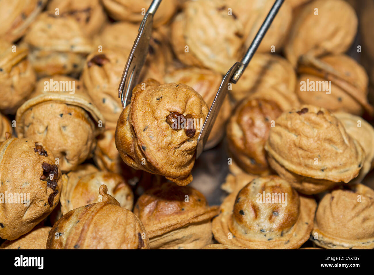 Chinese walnut filled muffin being held by a set of prongs Stock Photo ...