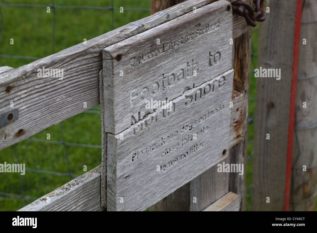 Engraved wood sign, saying 'Footpath to North Shore'. Naturally sand ...