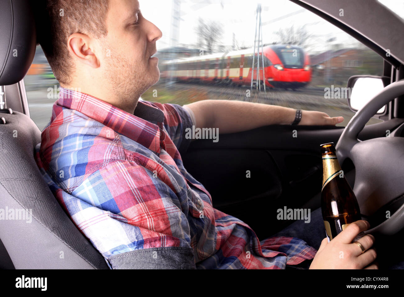 Drunk man with the beer goes straight for the train Stock Photo - Alamy