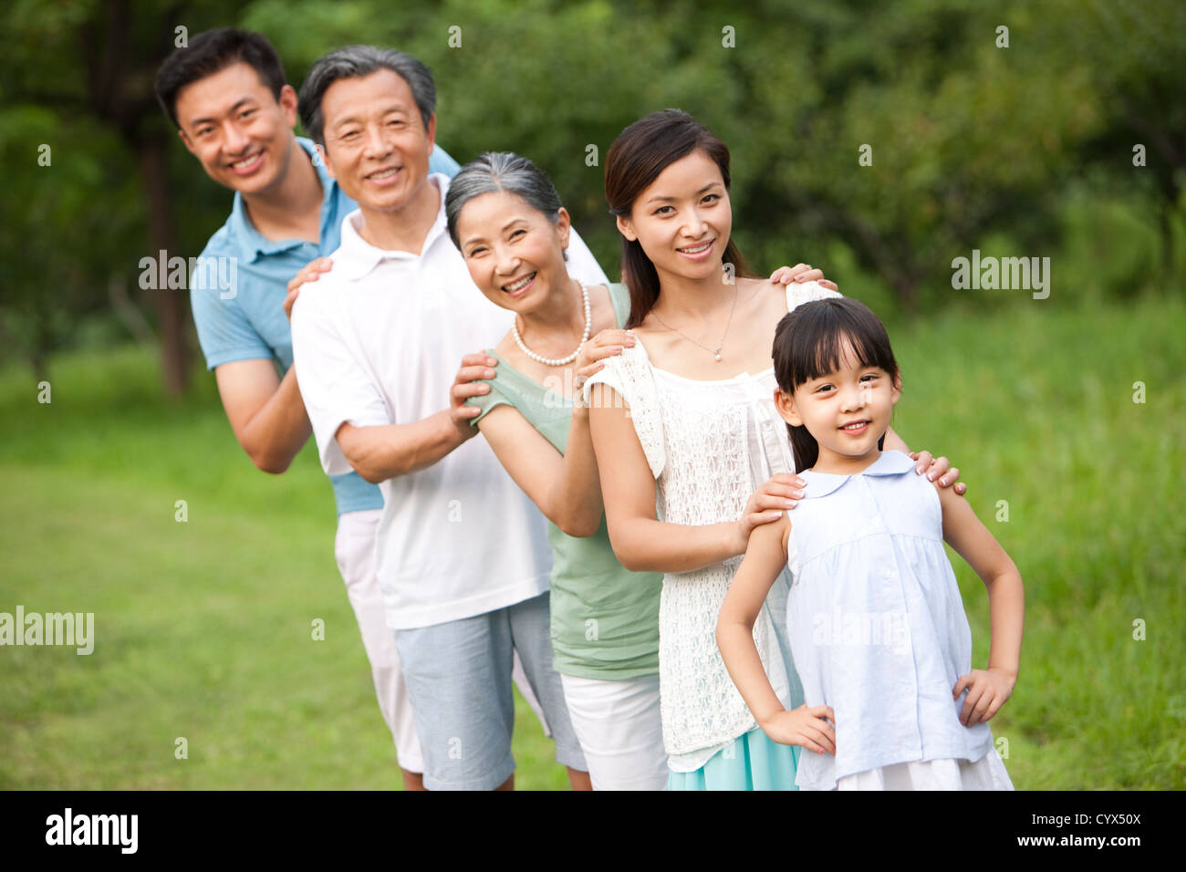 Happy family standing in a row outdoors Stock Photo - Alamy