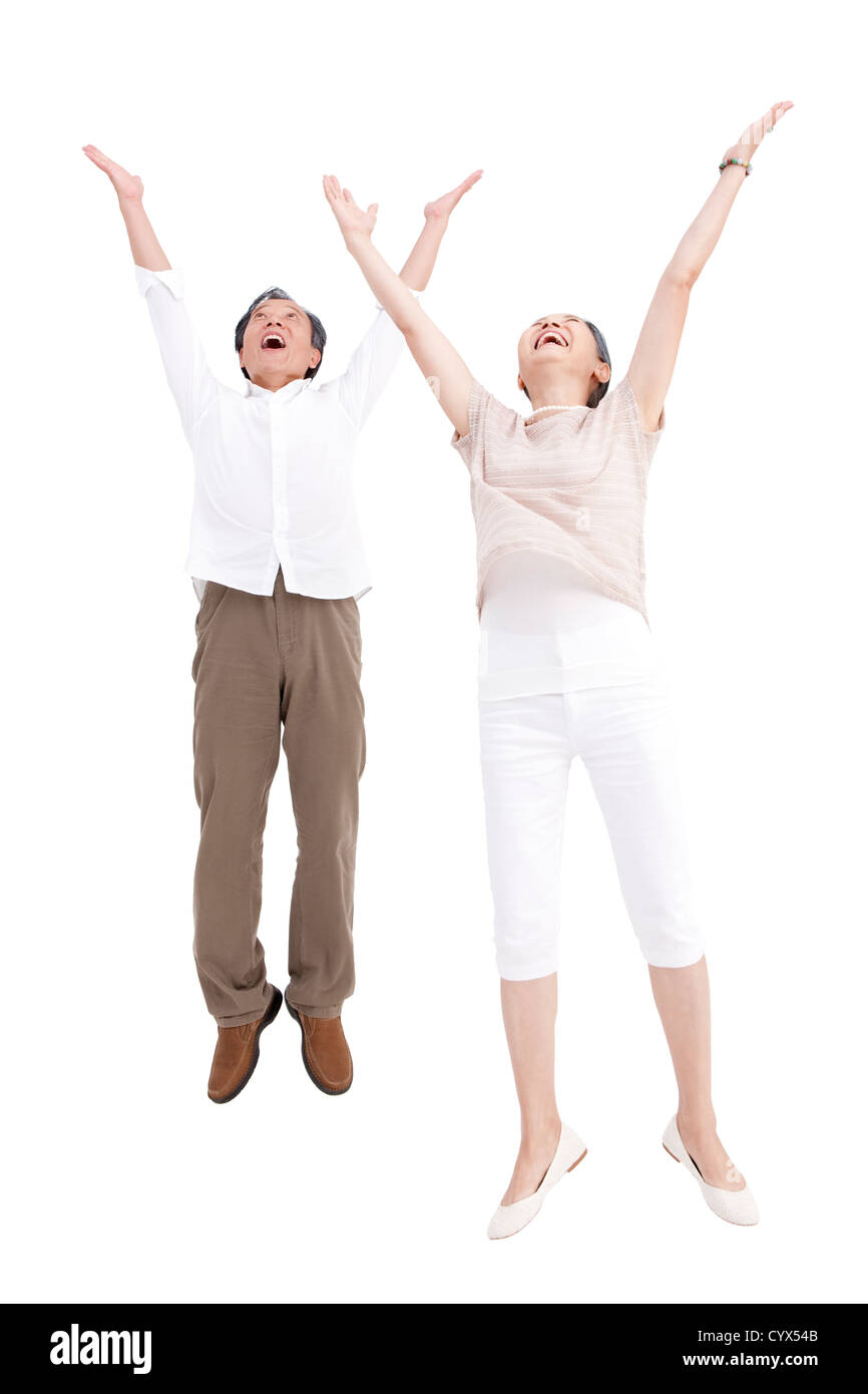 Excited senior couple jumping in mid-air Stock Photo - Alamy