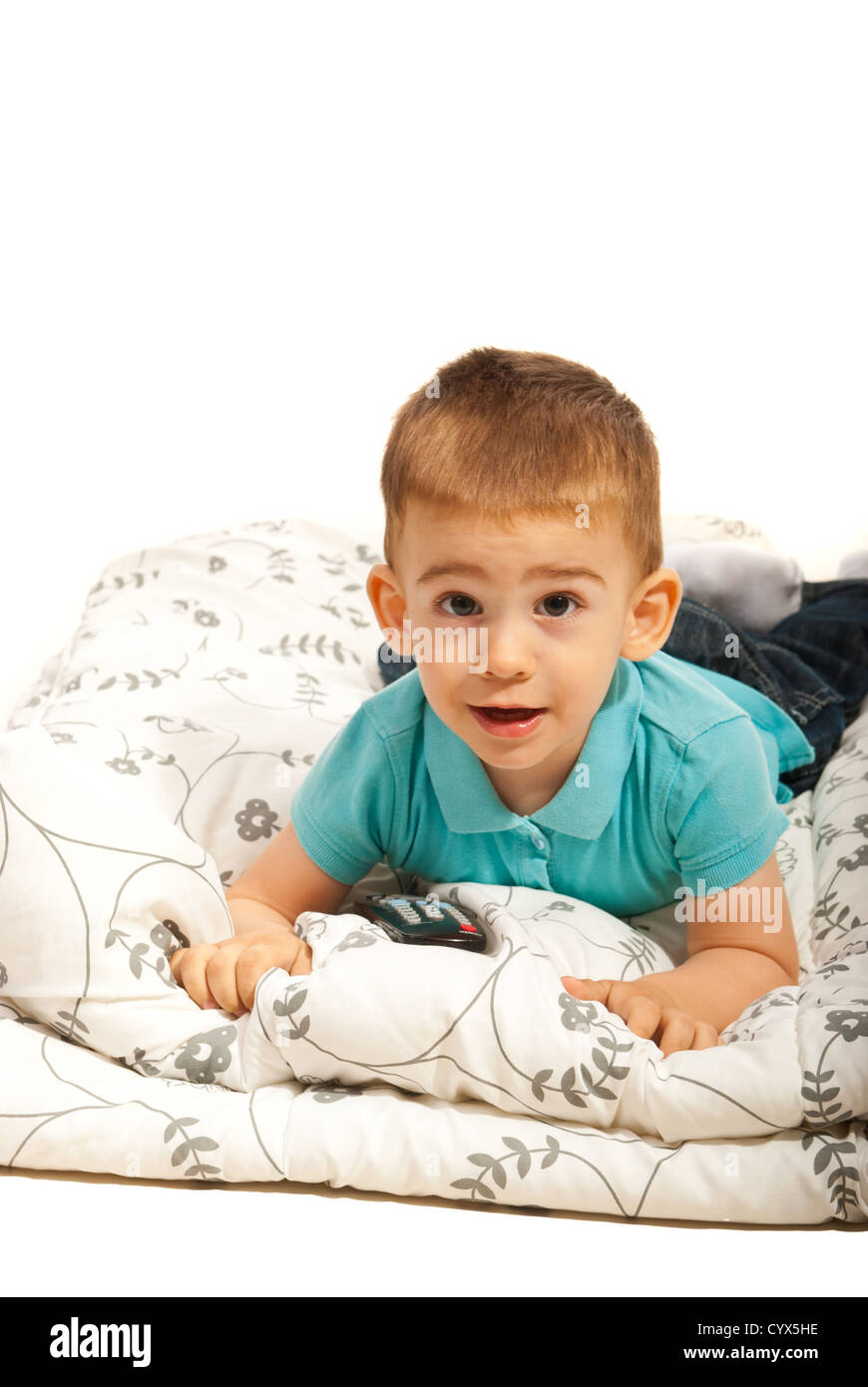 Amazed toddler boy lying down on a blanket against white background ...