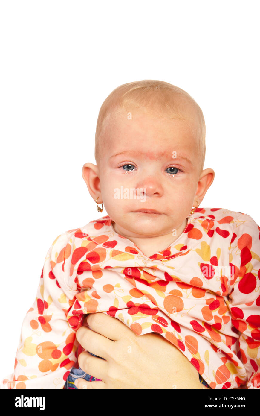 Crying baby girl with tears in her mother hands isolated on white ...