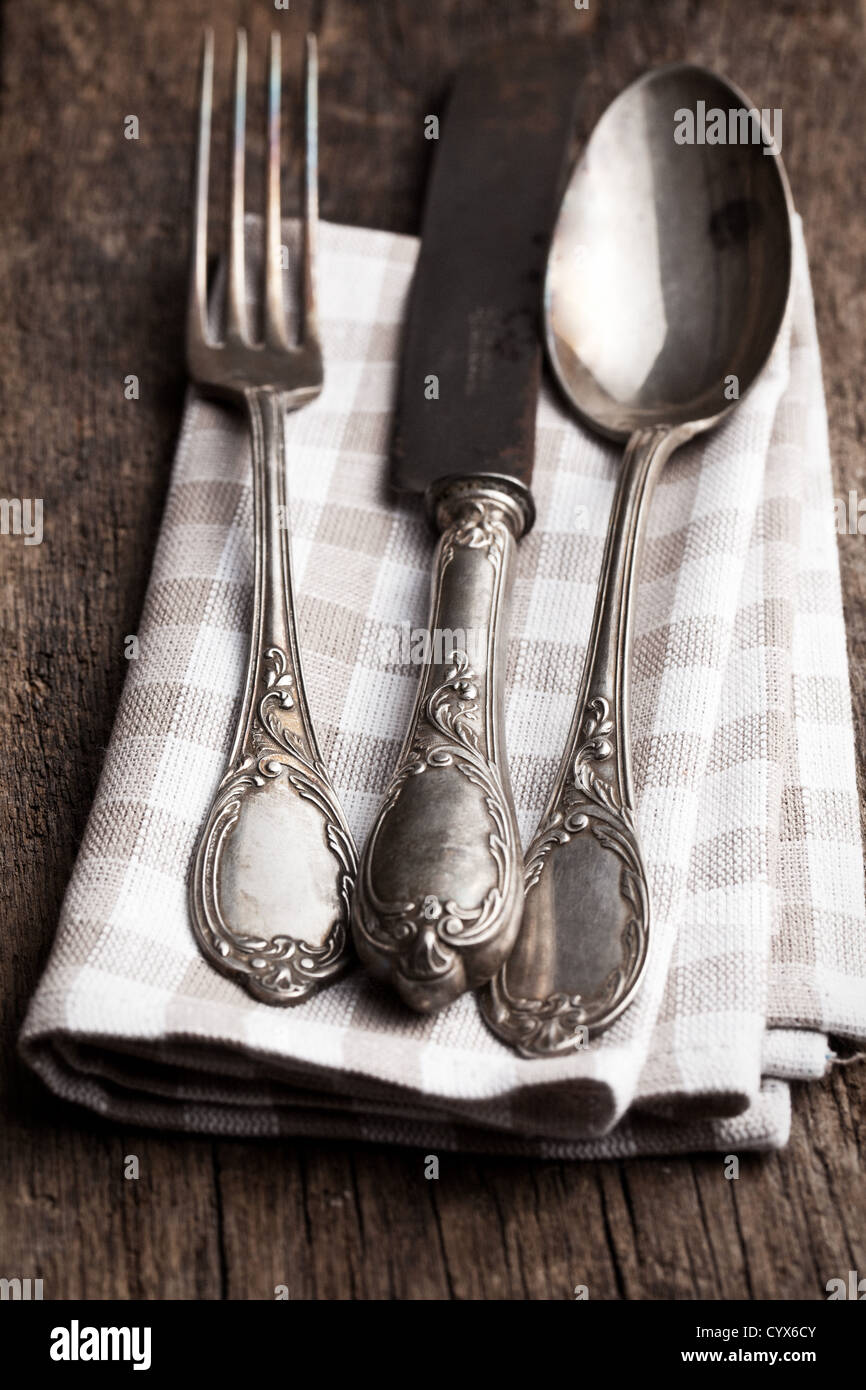 old cutlery on wooden table Stock Photo - Alamy