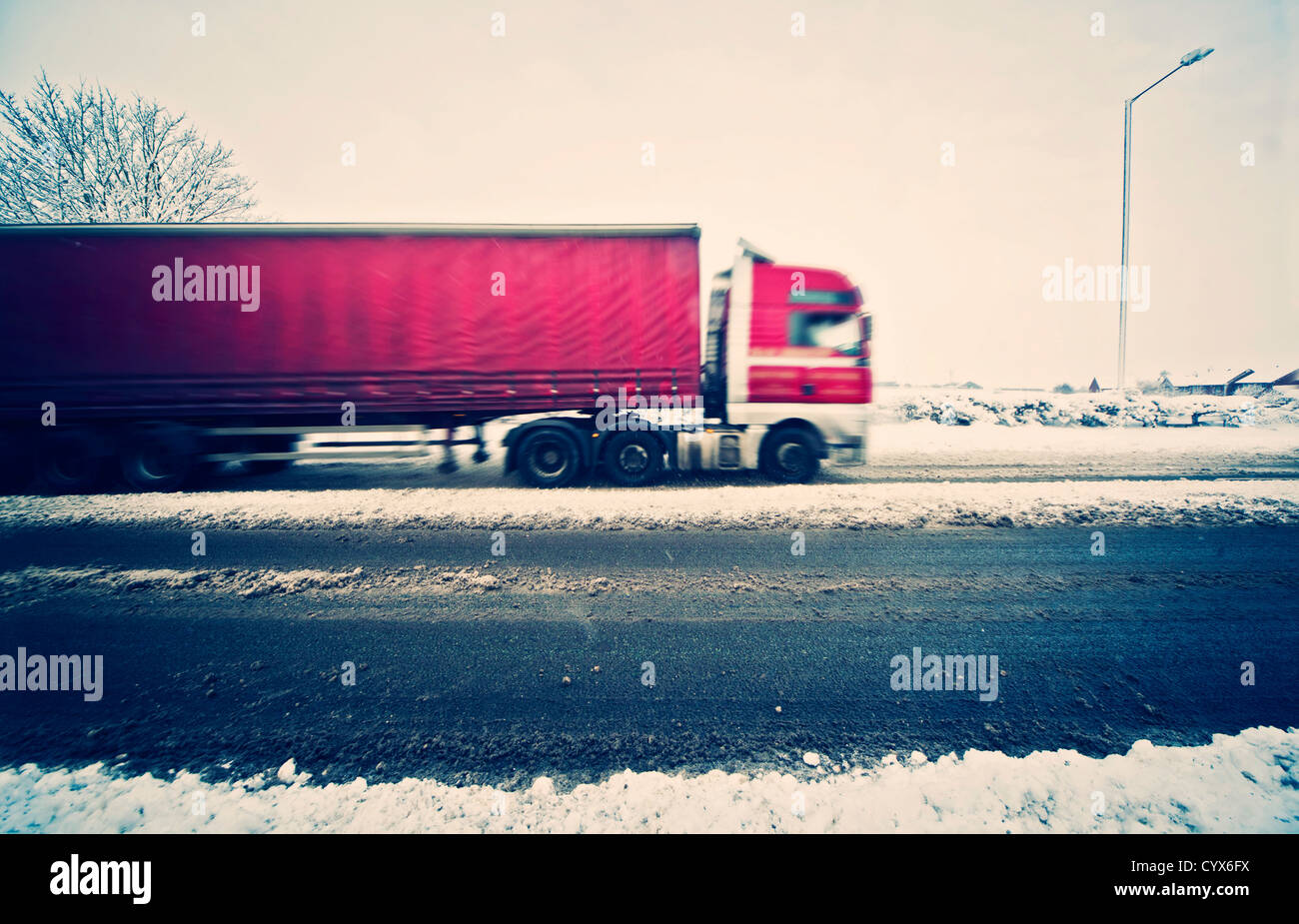 Lorry driving in the snow Stock Photo - Alamy