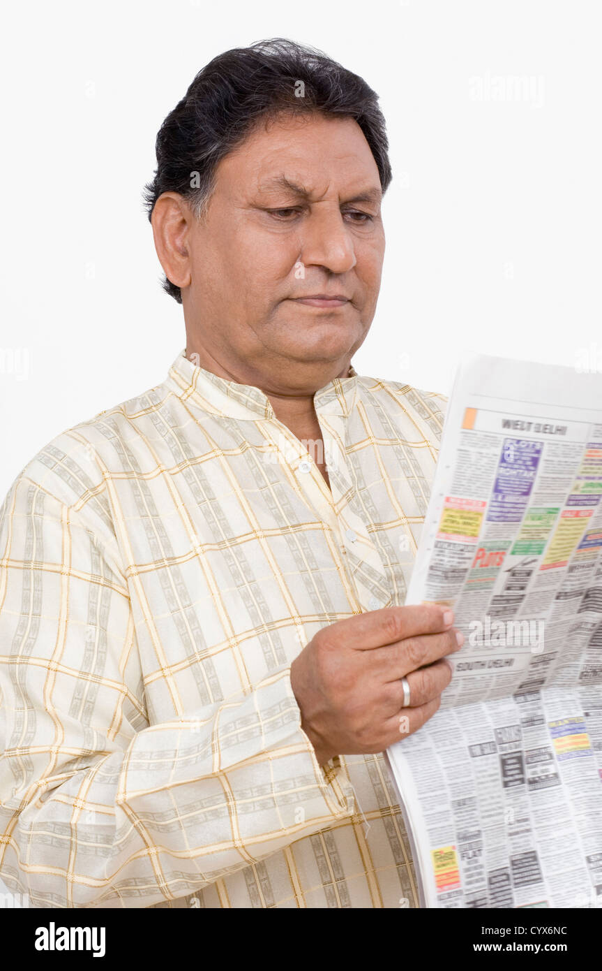 Man reading a newspaper Stock Photo - Alamy