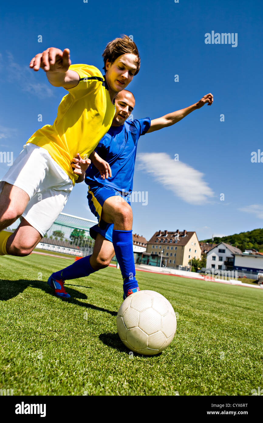 two football players from opposing team on the field Stock Photo - Alamy