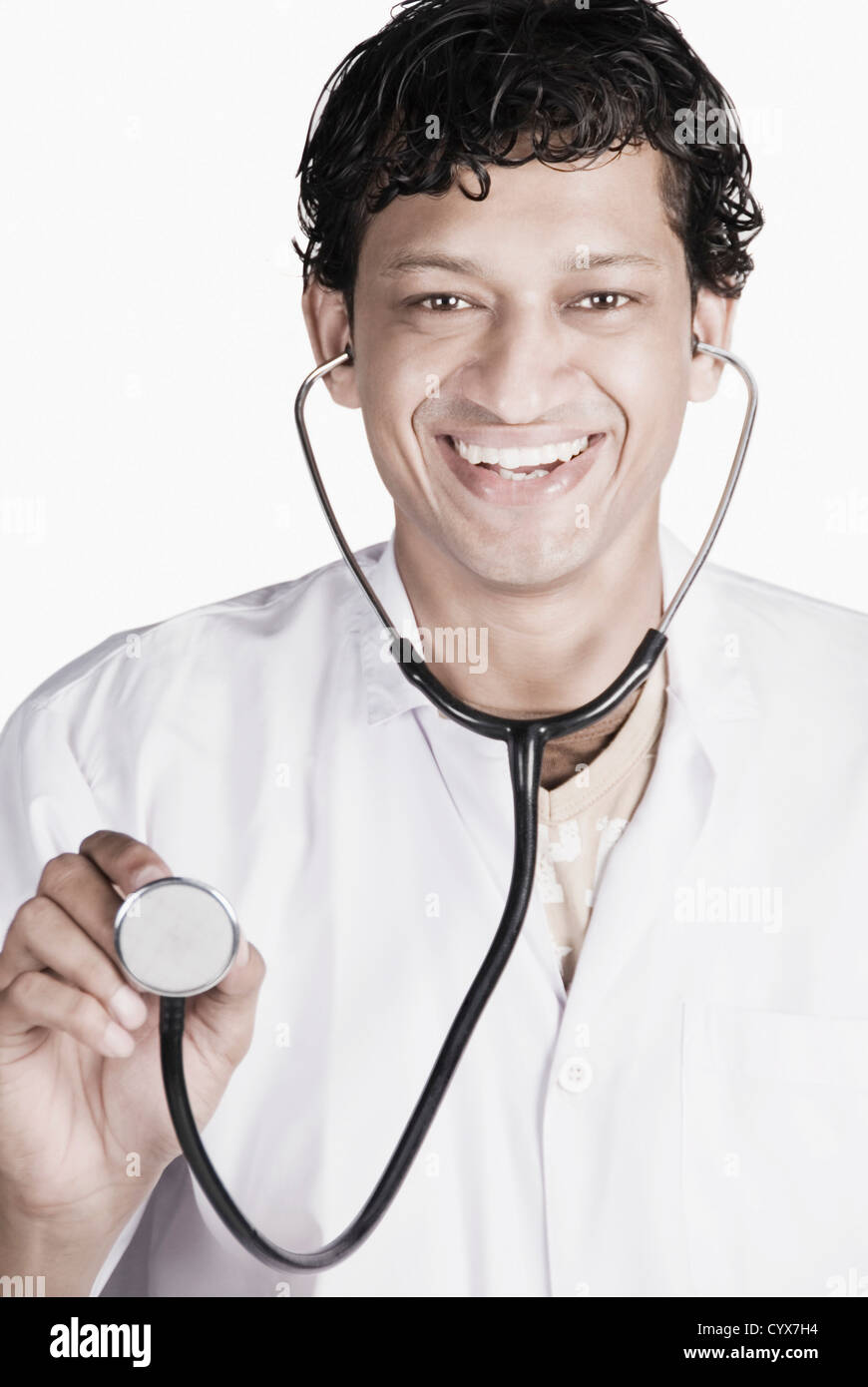 Male doctor holding a stethoscope Stock Photo - Alamy