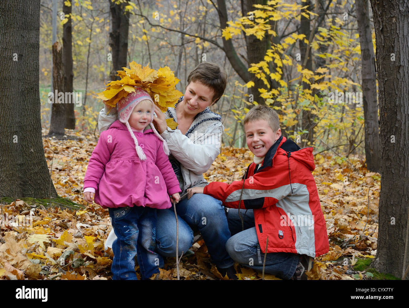 family plays in the autumn woods Stock Photo - Alamy