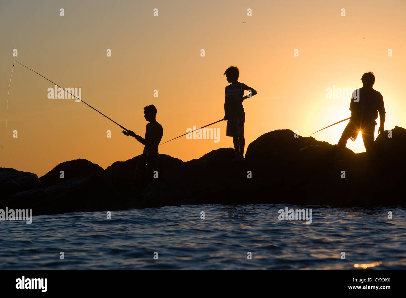 Three people fishing hi-res stock photography and images - Alamy