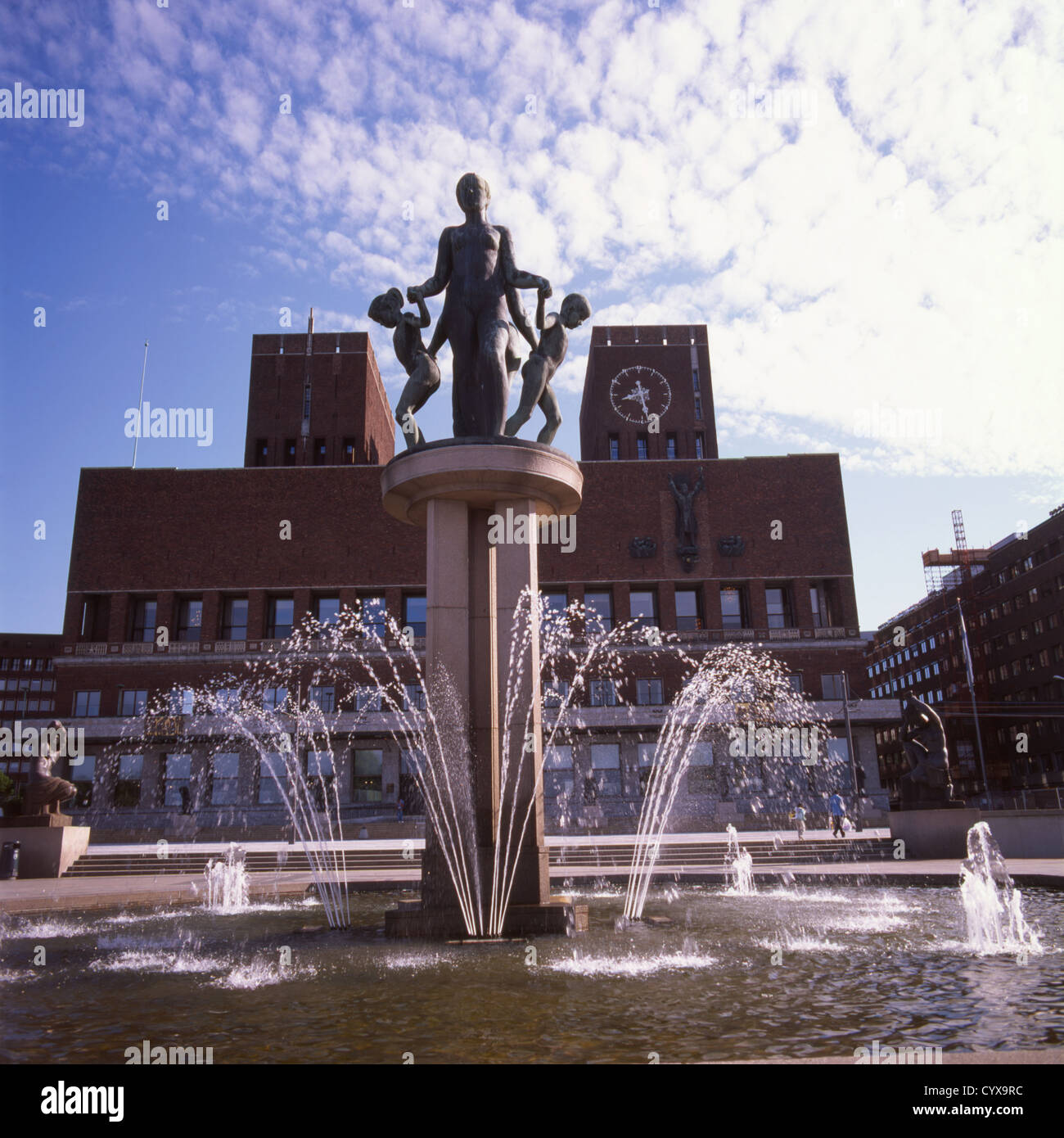 Fountain with brick building beyond Stock Photo - Alamy