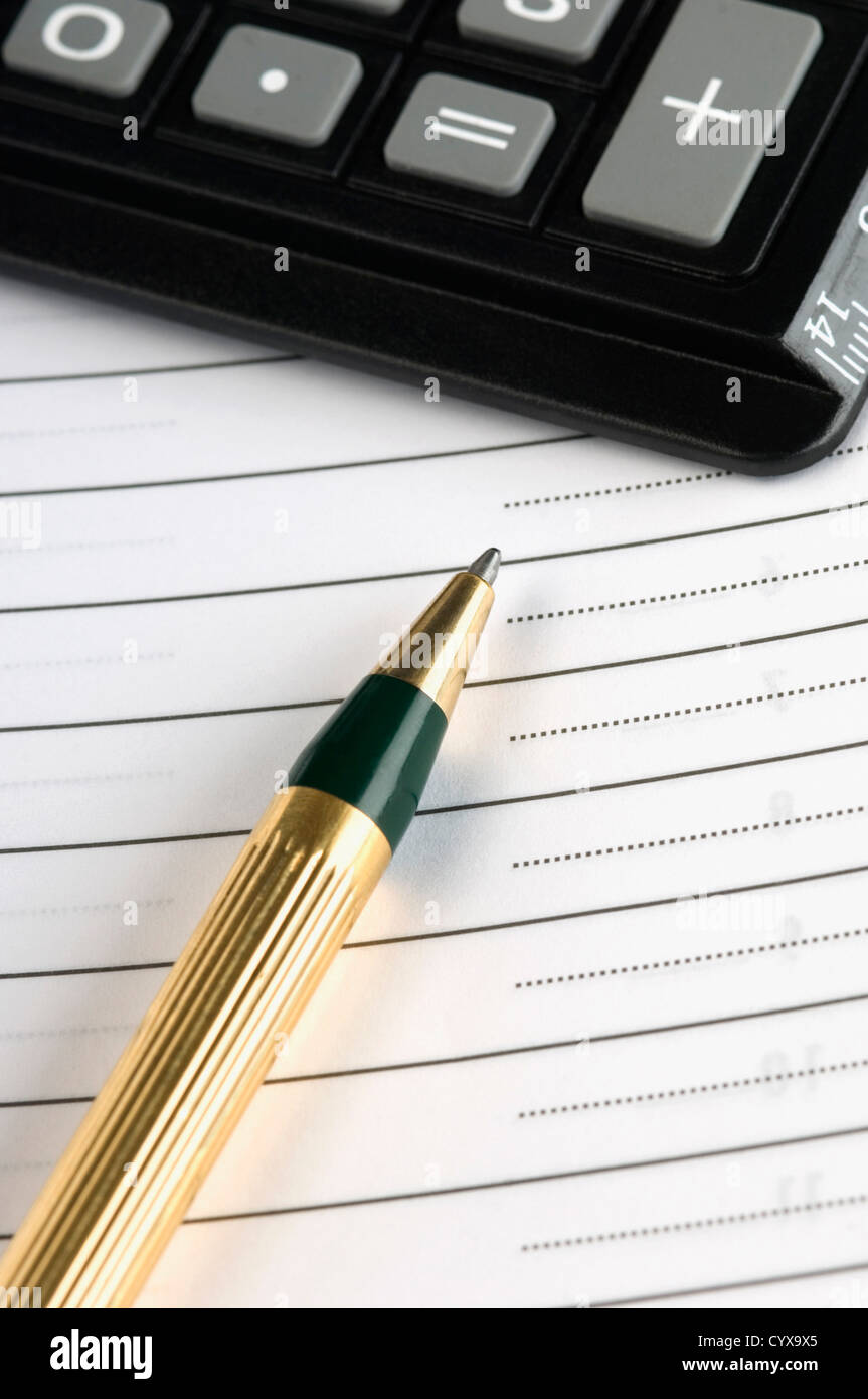 Ballpoint pen and a calculator on a personal organizer Stock Photo - Alamy