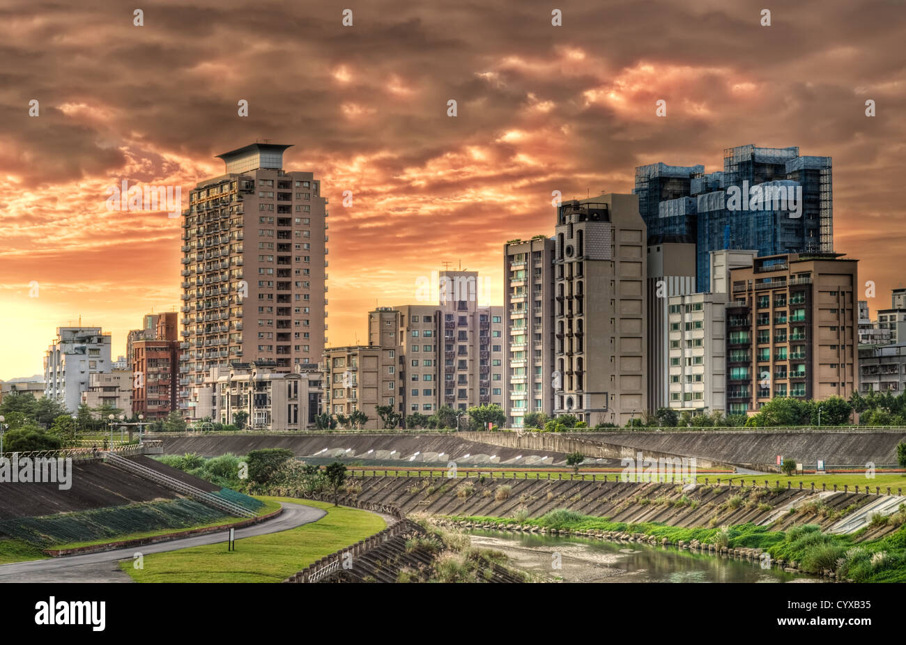 View of city landscape with buildings and park near river Stock Photo ...