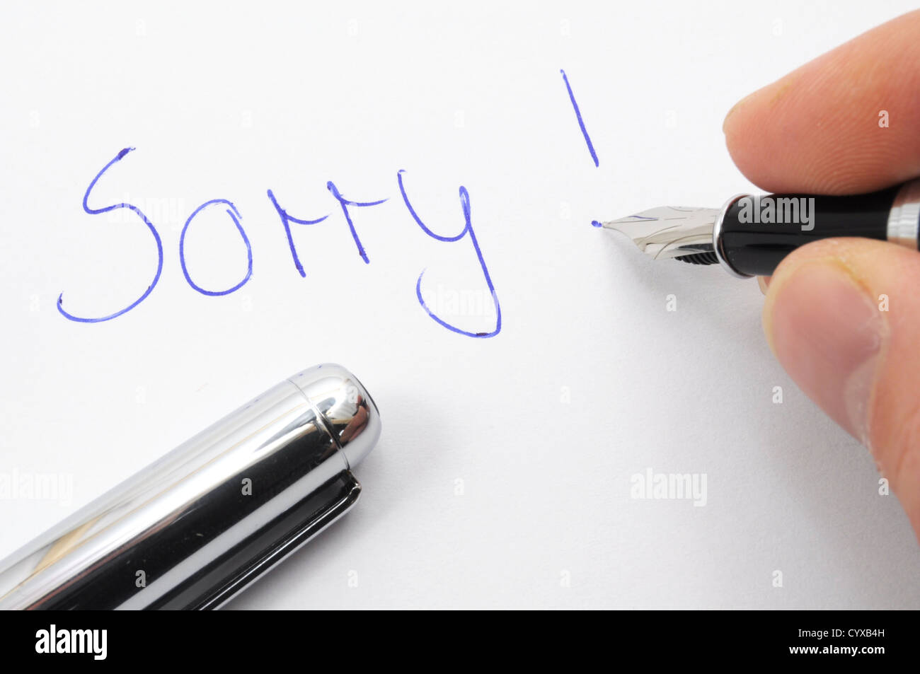 say sorry with a text message on paper and pen Stock Photo - Alamy