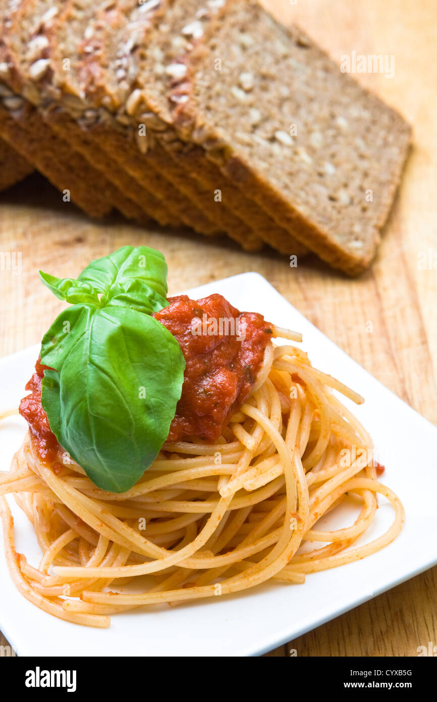 Fresh spaghetti with tomato sauce and freshly sliced bread Stock Photo ...
