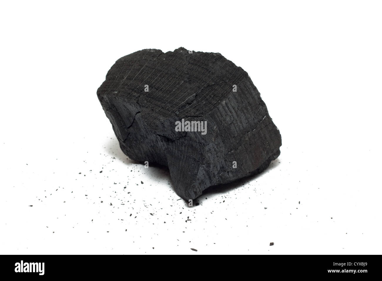 Bit of charcoal isolated on white with crums around Stock Photo - Alamy