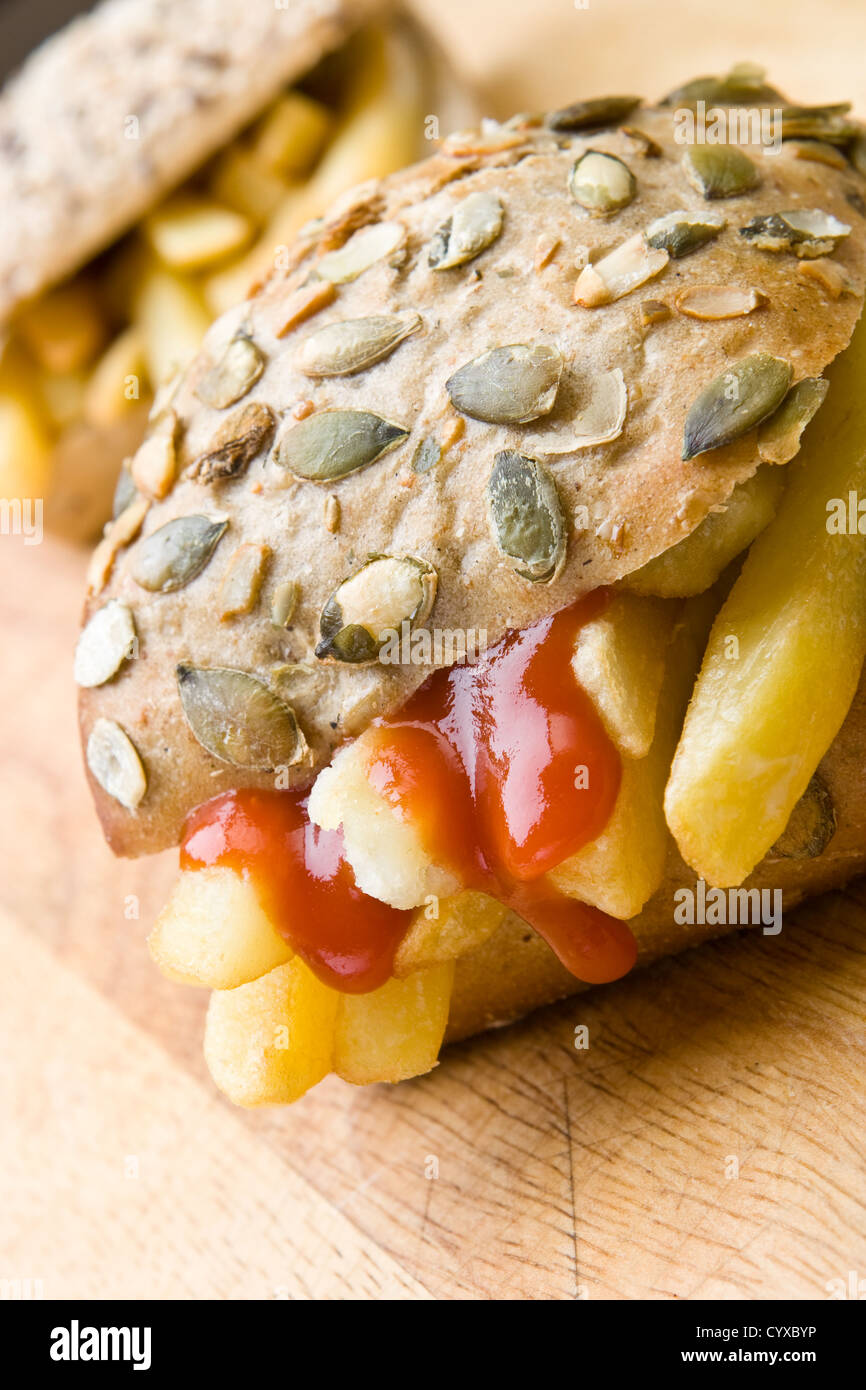 Chips in a wholemeal bread bun with ketchup Stock Photo - Alamy