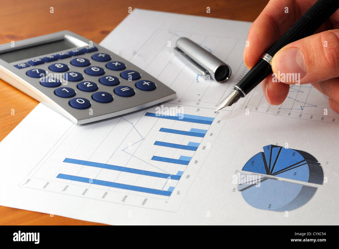 business chart graph or diagram and hand on desktop Stock Photo - Alamy