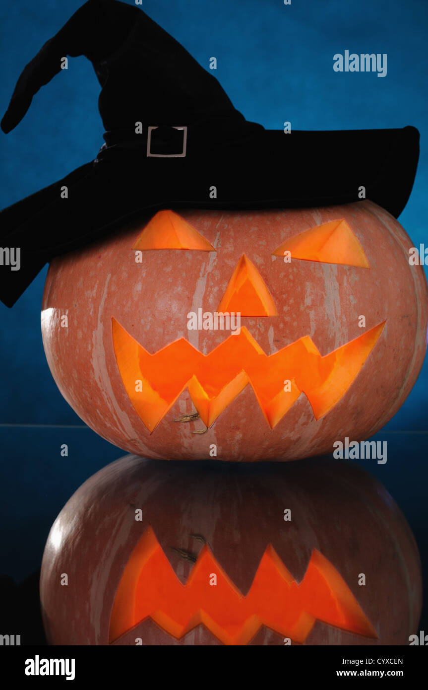 pumpkin with lighting candle inside on darck blue background Stock ...
