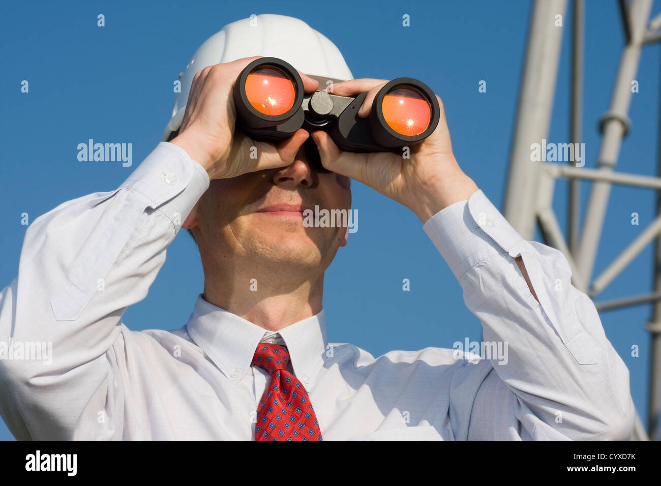 Engineer with binoculars on construction site Stock Photo - Alamy
