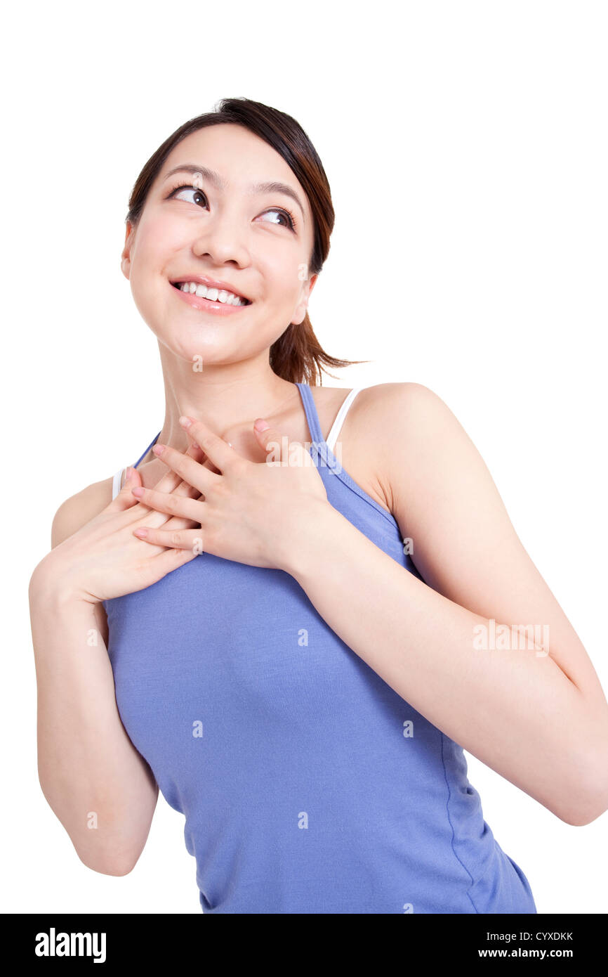 Joyful young woman putting hands on chest Stock Photo - Alamy