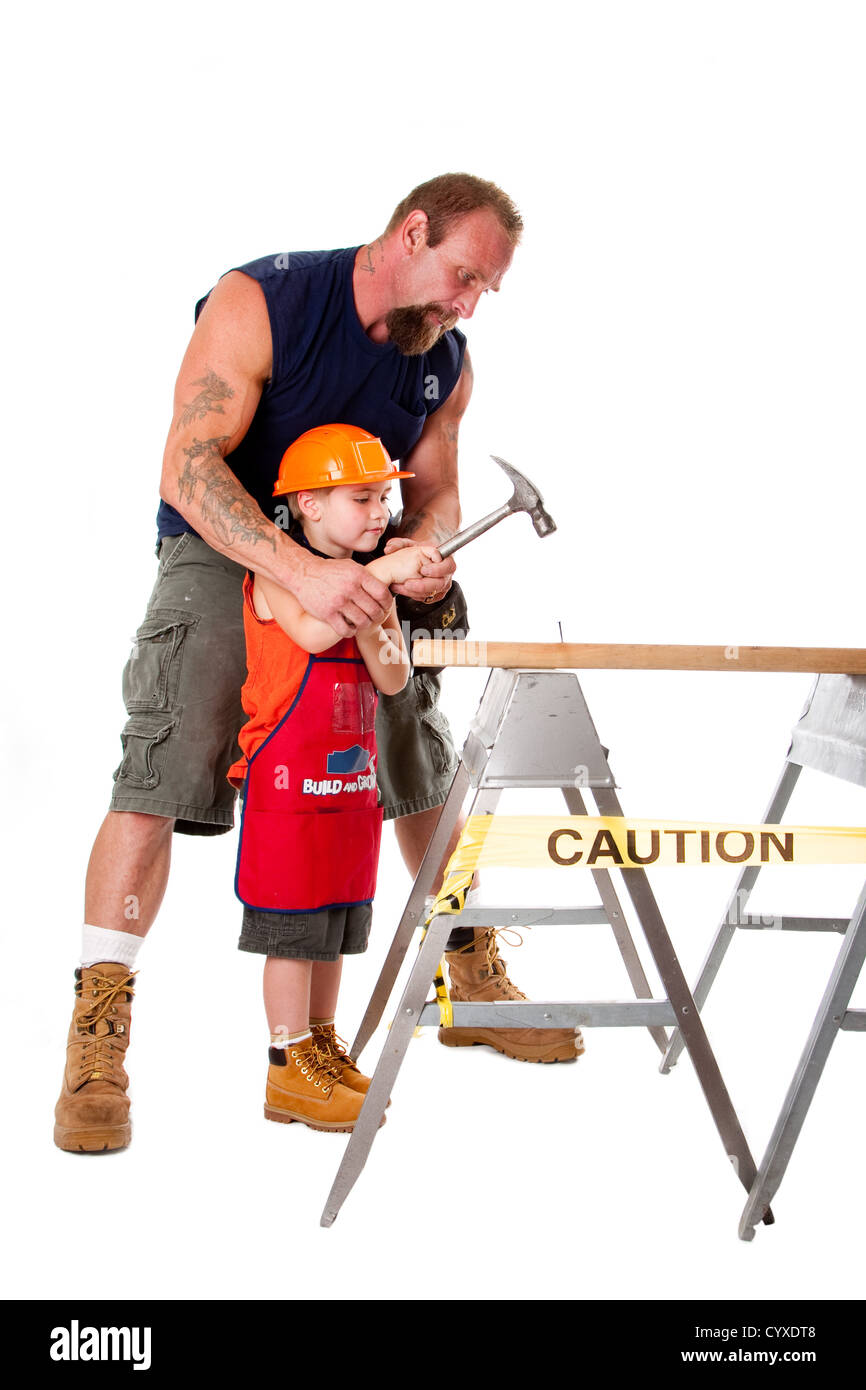 Caucasian father teaching his cute son how to hold a hammer and hit a ...