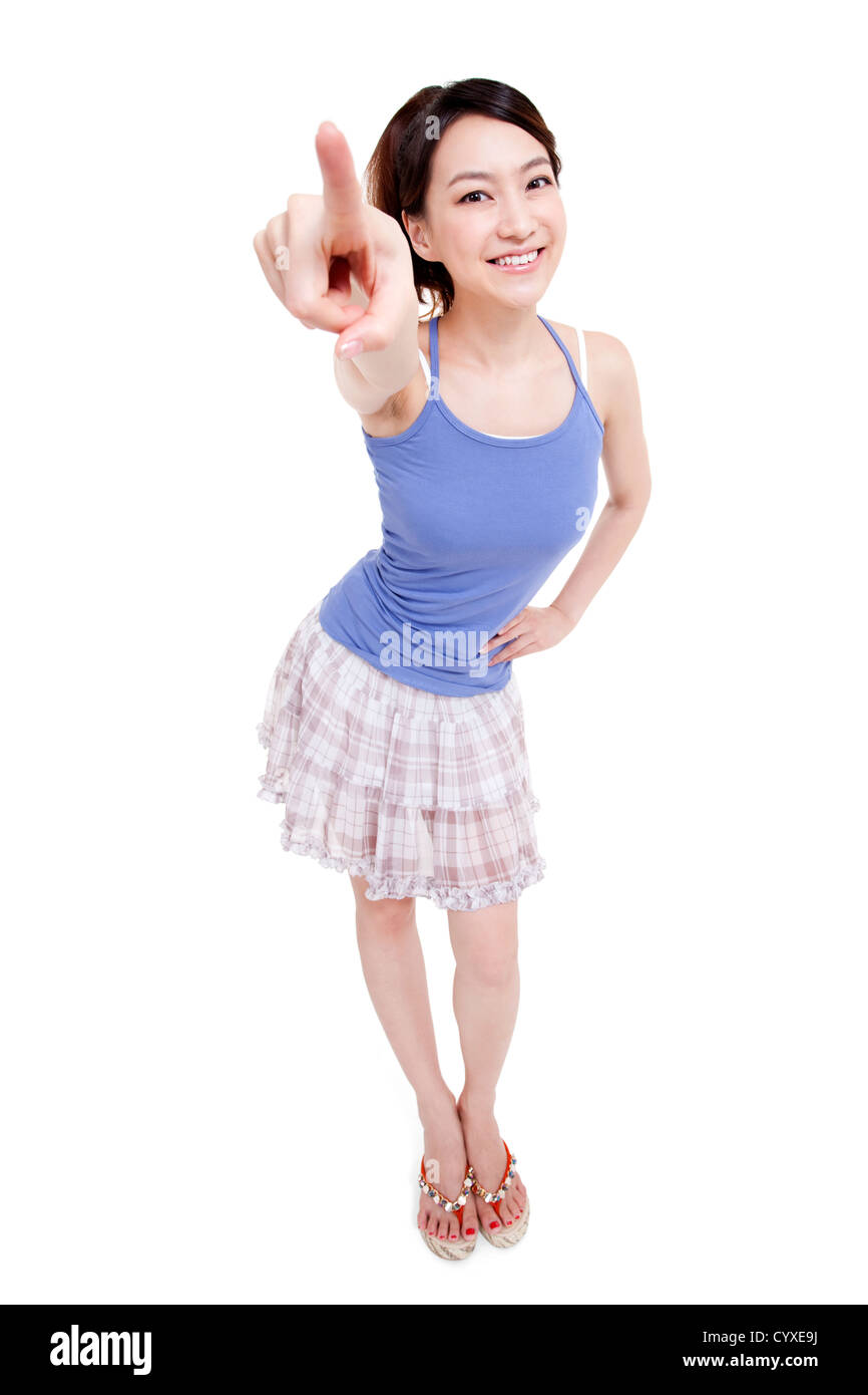 Cheerful young woman pointing forward Stock Photo - Alamy
