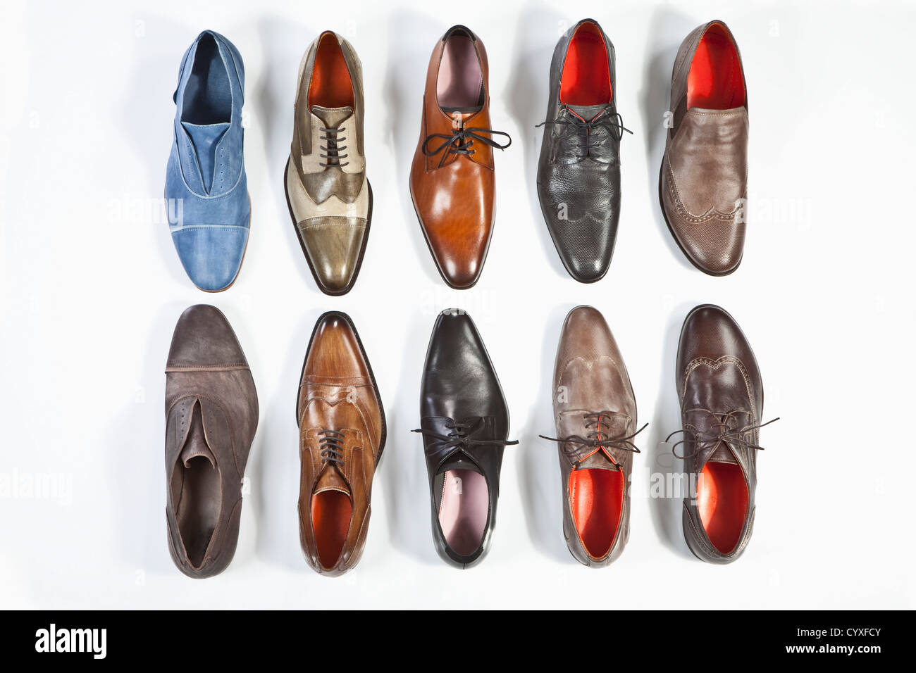 Row of shoes on white background Stock Photo - Alamy