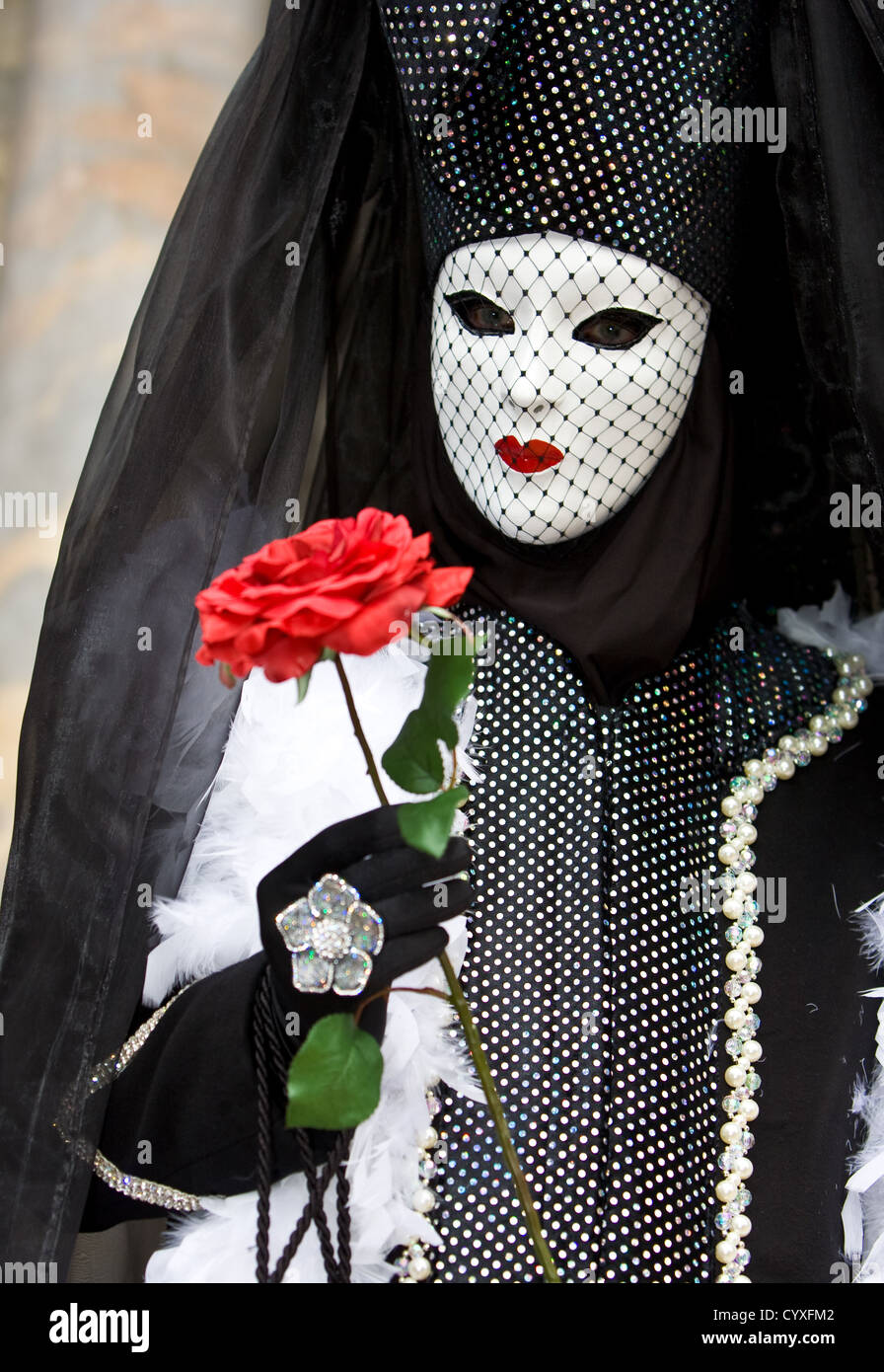A venetian lady with a white mask, red lips and a red rose Stock Photo ...