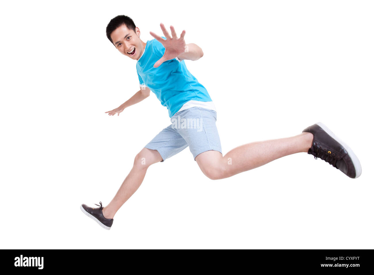 Excited young man running Stock Photo - Alamy