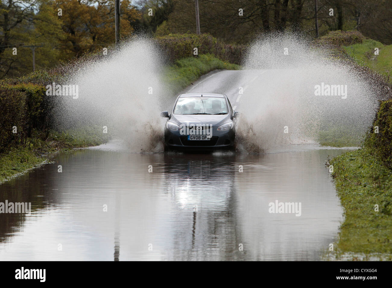 Flooded country road with cars driving slowly through waters hi-res ...