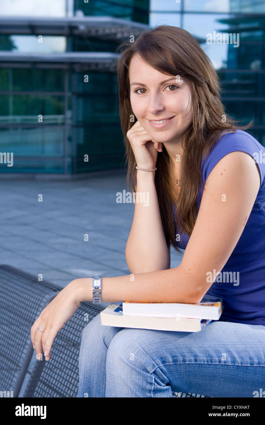 Pretty attractive caucasian girl sitting relaxing outside college ...