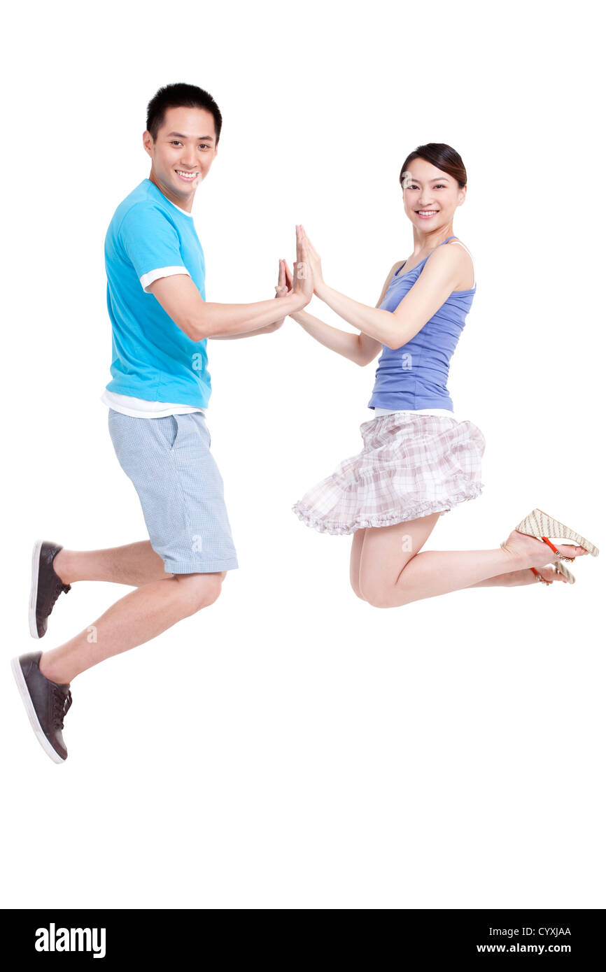 Young couple jumping excitedly Stock Photo - Alamy