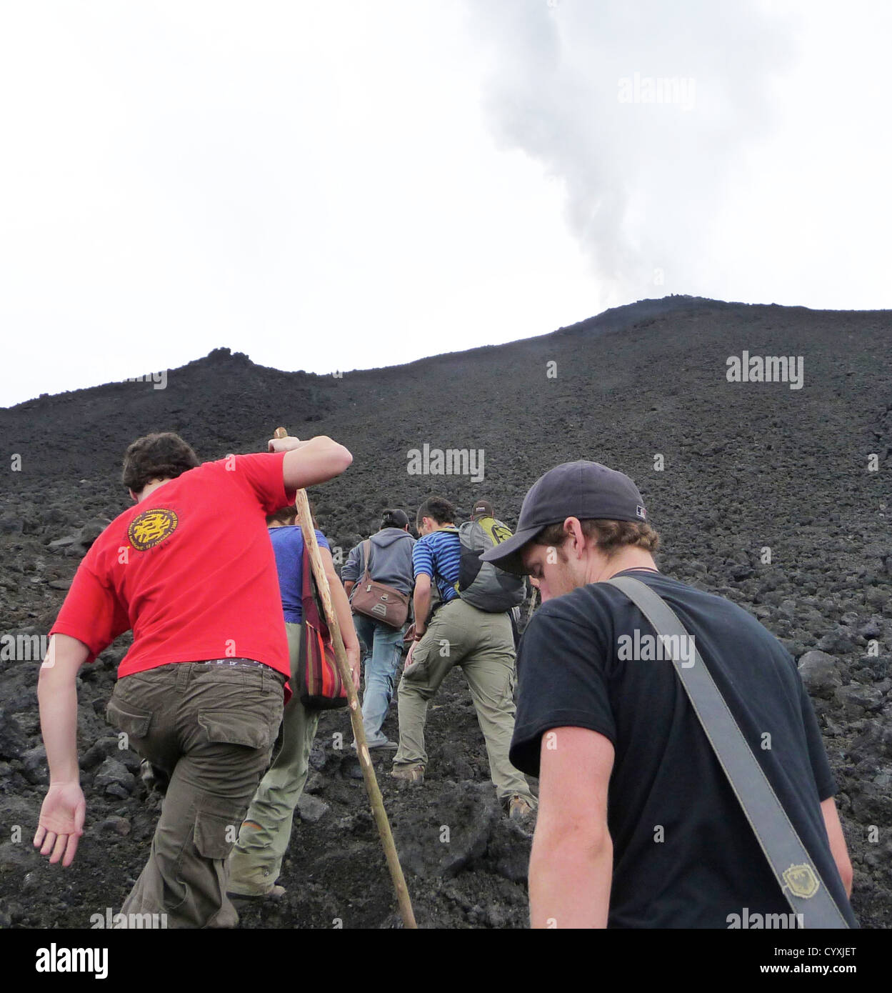 Climbing a fresh lava field in Guatemala - volcanic action Stock Photo ...