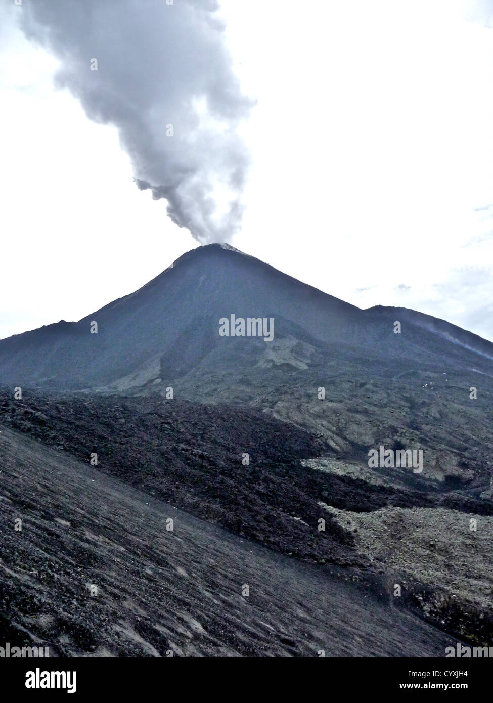 Climbing a fresh lava field in Guatemala - volcanic action Stock Photo ...