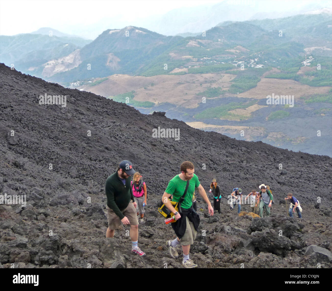 Climbing a fresh lava field in Guatemala - volcanic action Stock Photo ...